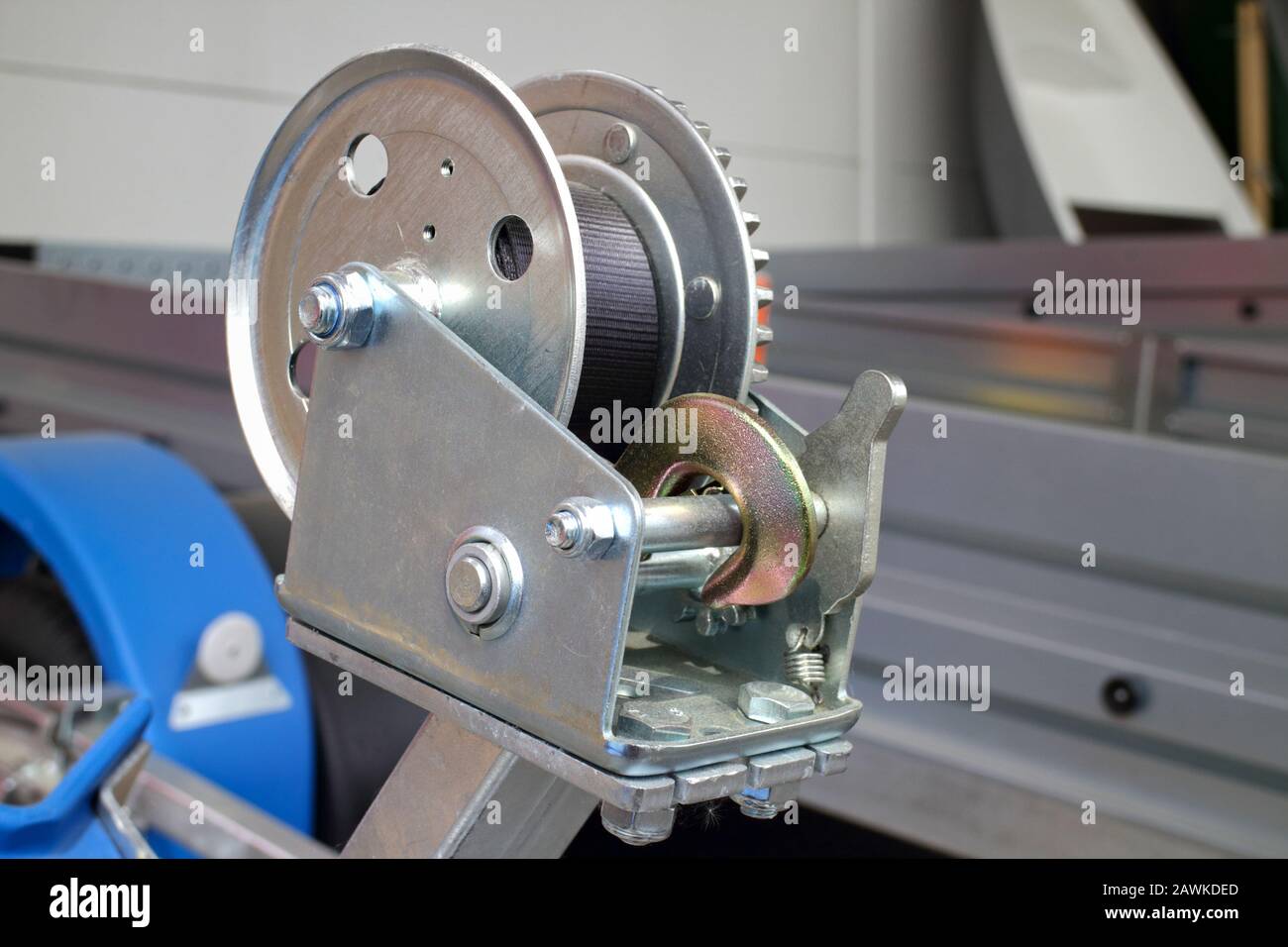 detailed photo of a small metal mechanical rope winch with a stainless ...