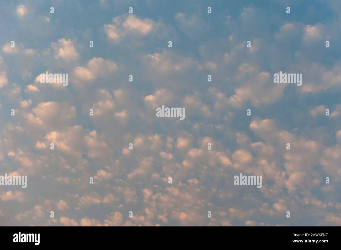 Cumulus sunset clouds with sun setting down Stock Photo - Alamy