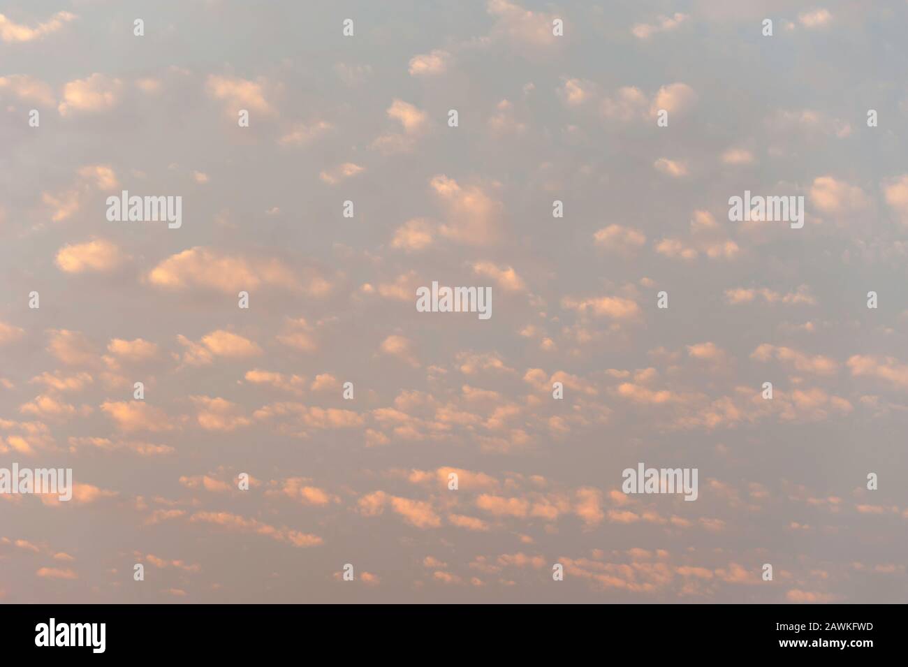 Cumulus sunset clouds with sun setting down Stock Photo - Alamy