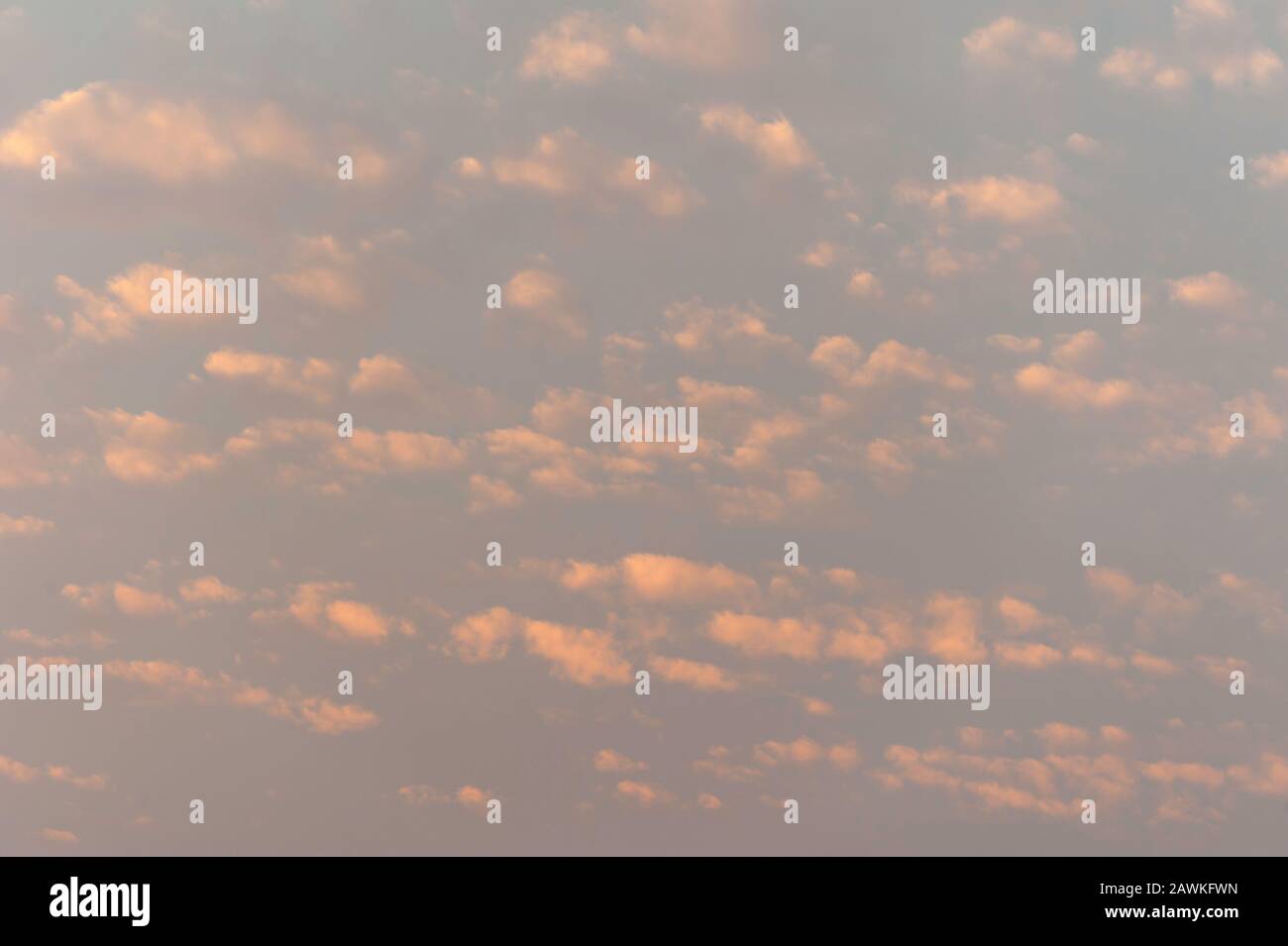 Cumulus sunset clouds with sun setting down Stock Photo - Alamy