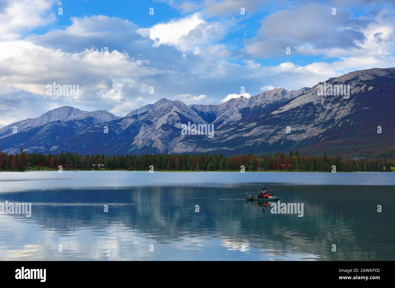 Beautiful sunrise over Edith Lake with colorful boat in foreground ...