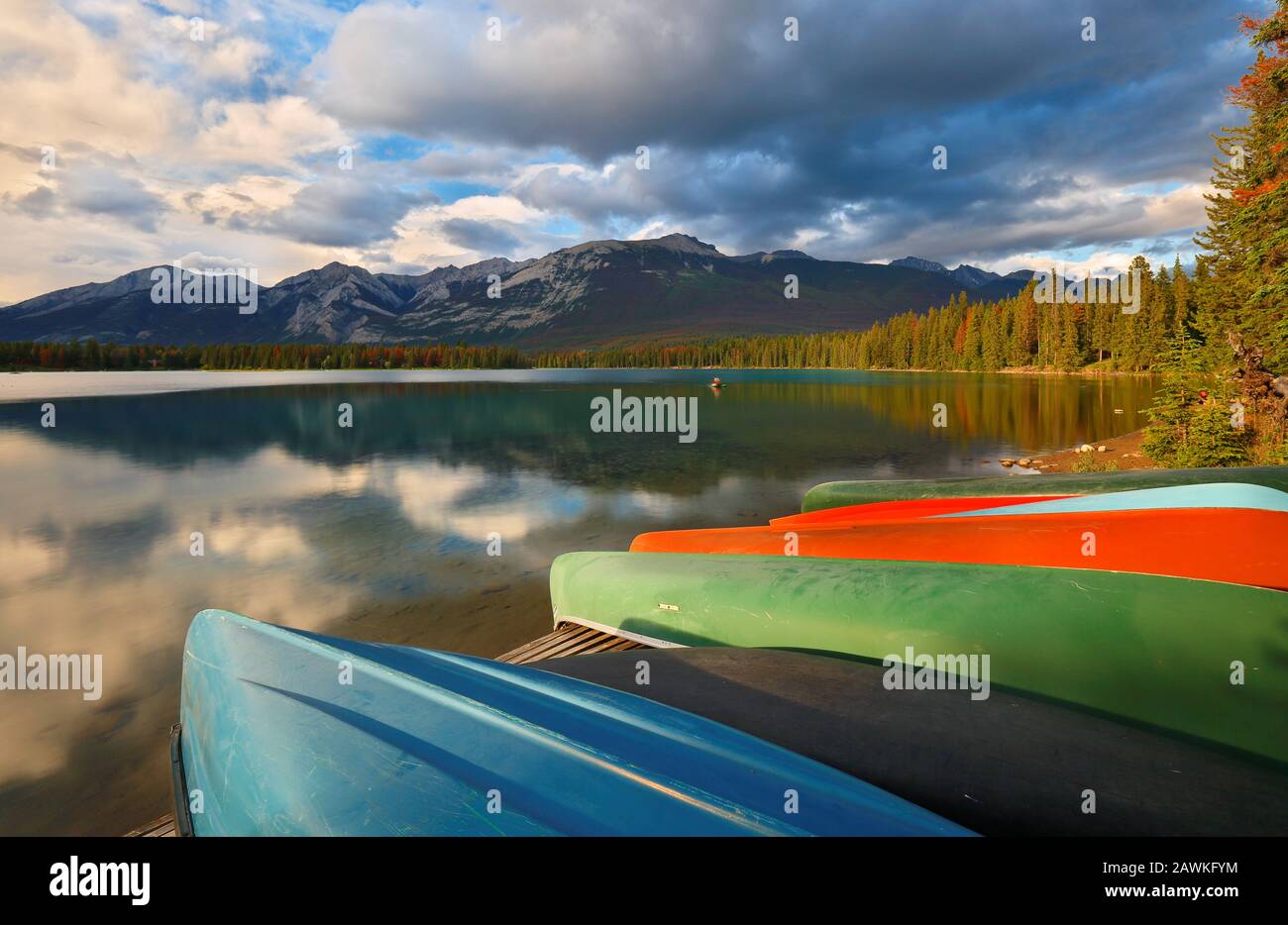 Beautiful sunrise over Edith Lake with colorful boat in foreground ...