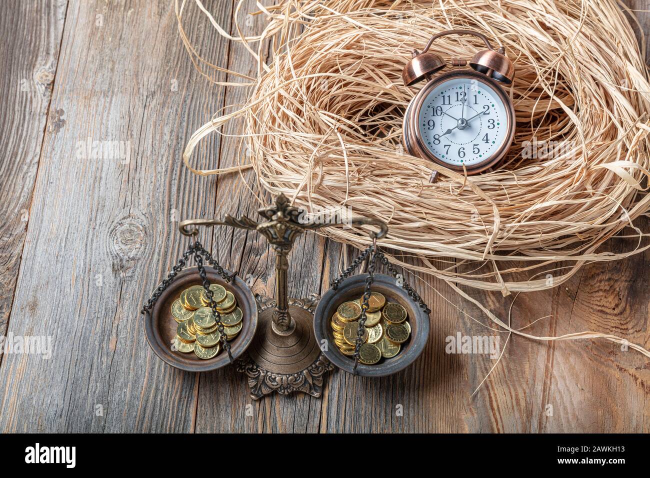 Balancing Time and Money Time is money concept with pile of coins with ...