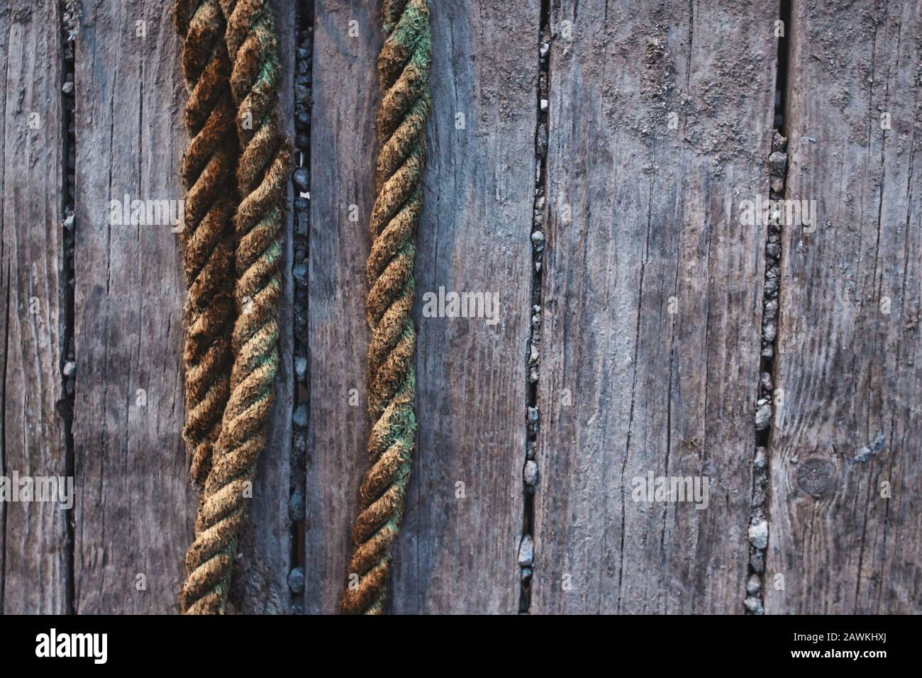 Yellow weathered ropes against rustic wooden boards Stock Photo - Alamy