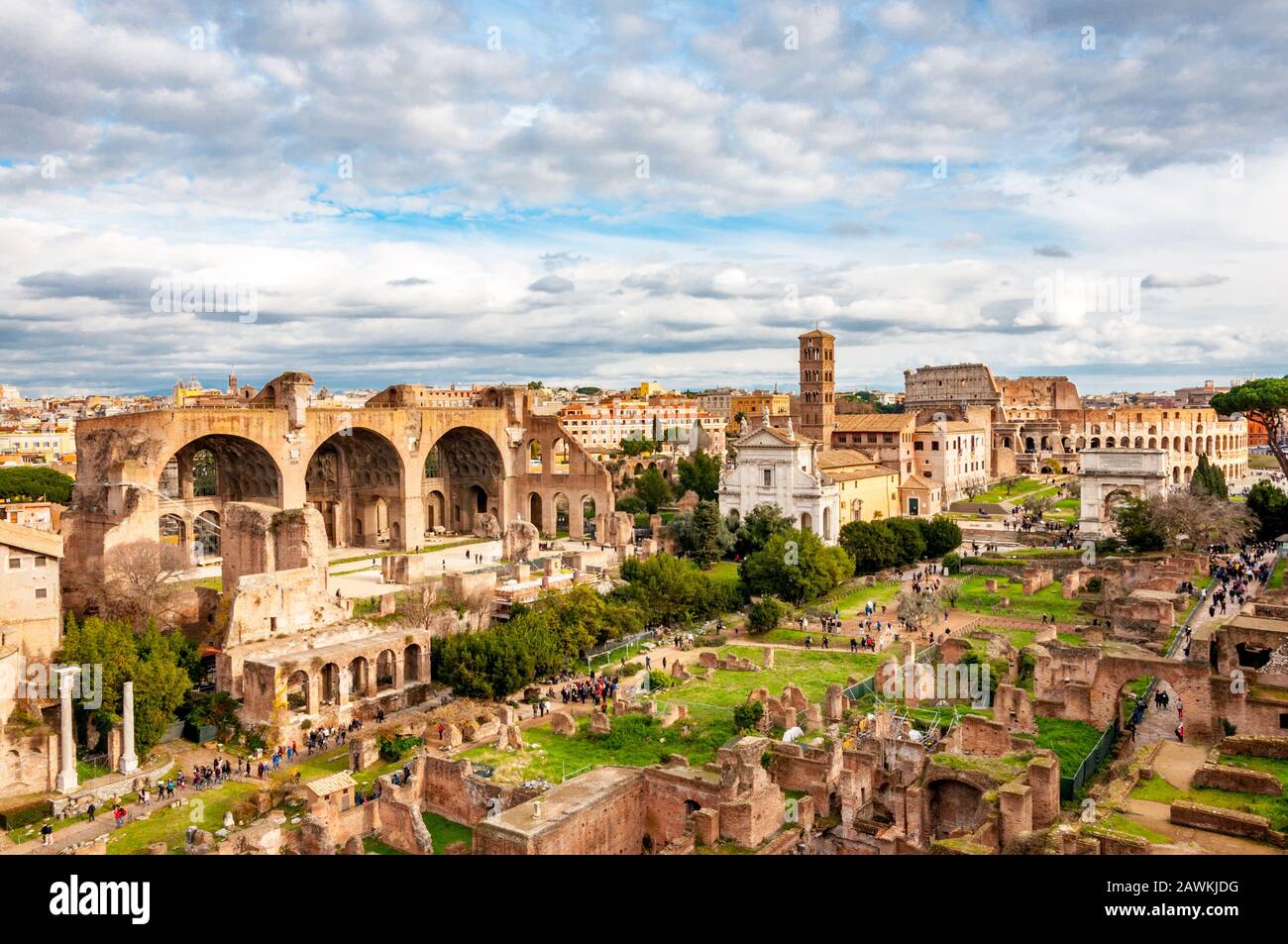 Colosseum and ancient Roman forum buildings under blue sky with clouds ...