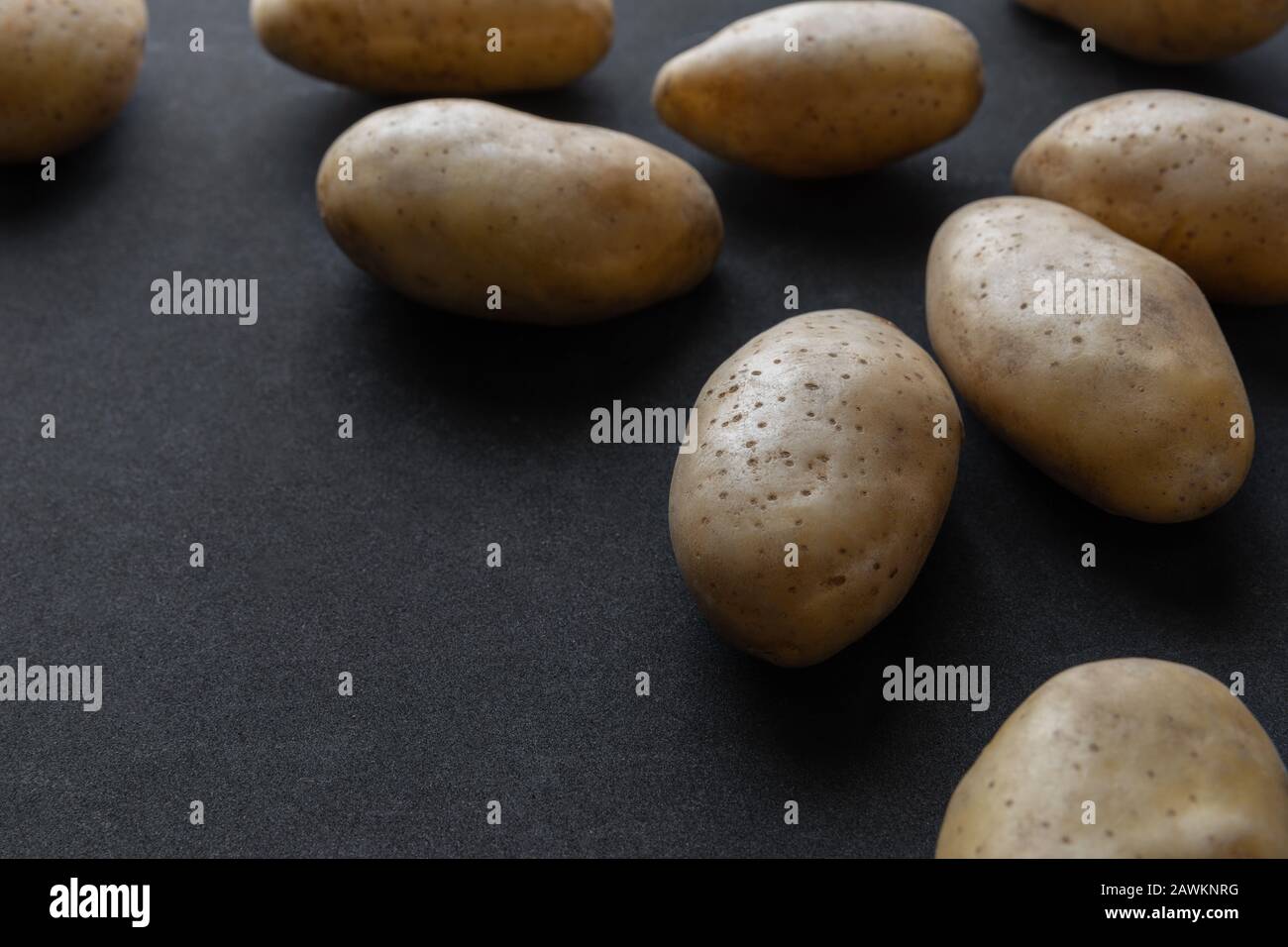 Frame of raw organic potatoes on dark background Stock Photo - Alamy