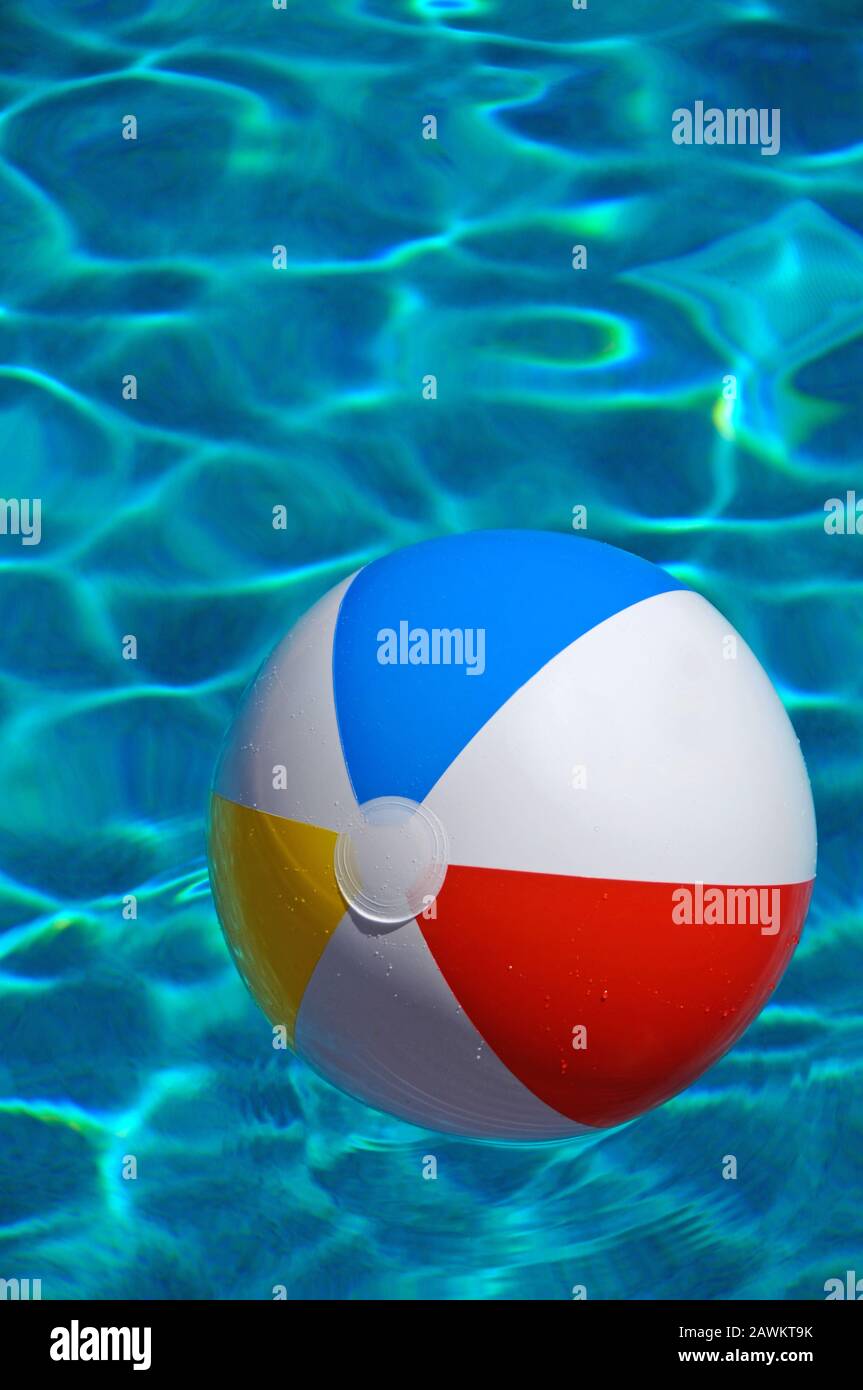 Beach Ball floating in the Swimming Pool Stock Photo - Alamy