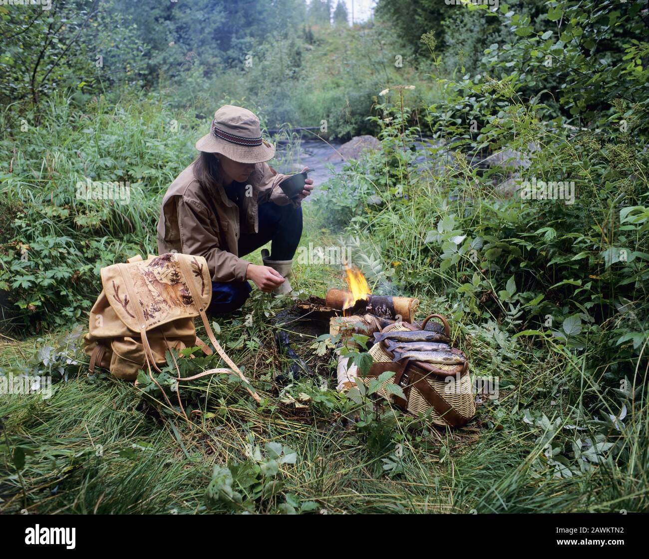 Fishing break by the fire Stock Photo - Alamy