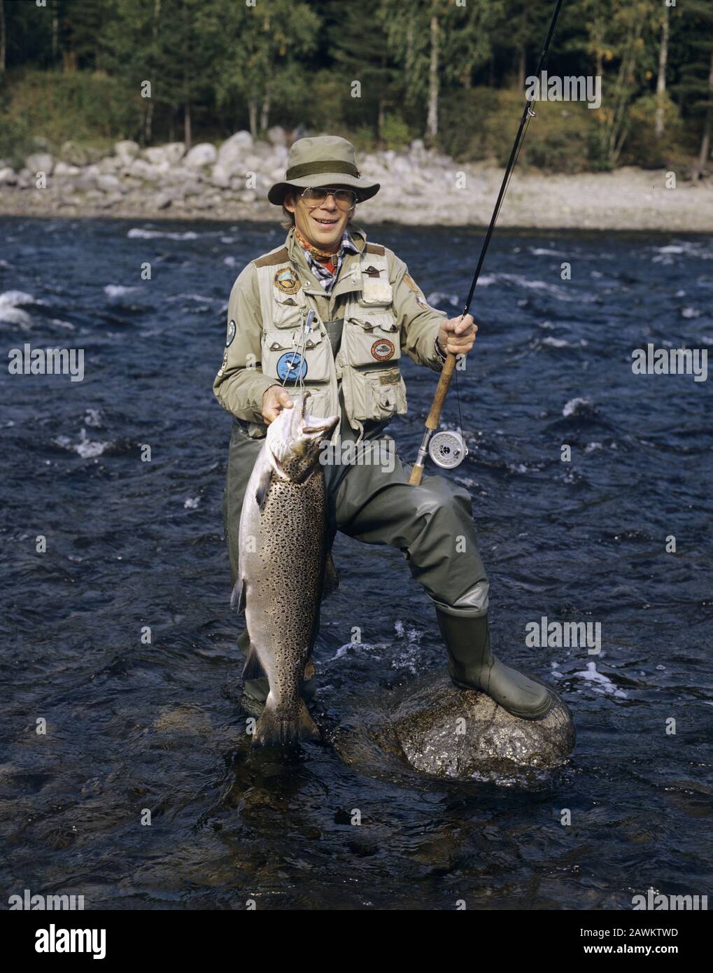 Fly fisherman with sea trout catch Stock Photo - Alamy