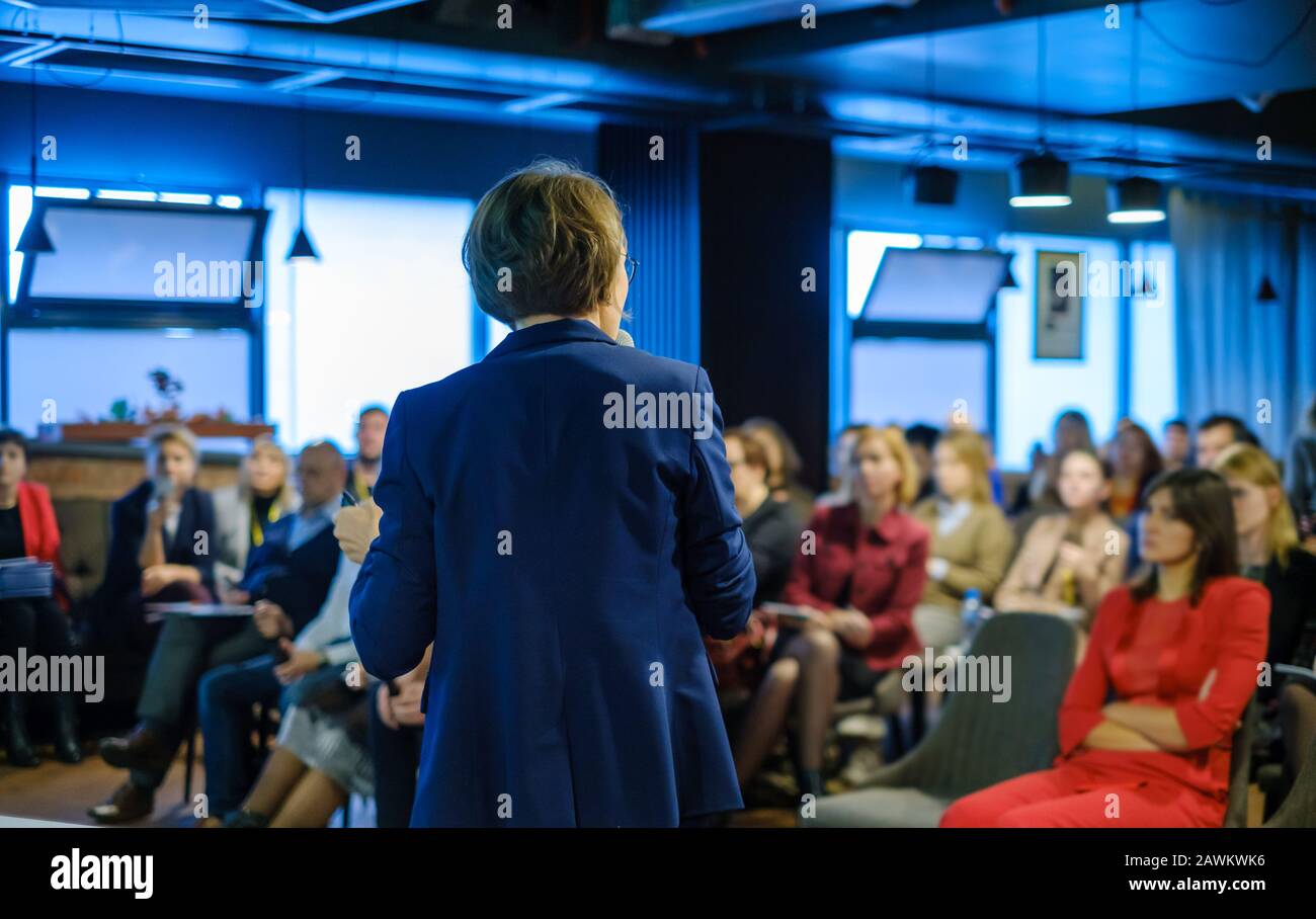 Female presenter speaks to audiences at seminar Stock Photo - Alamy