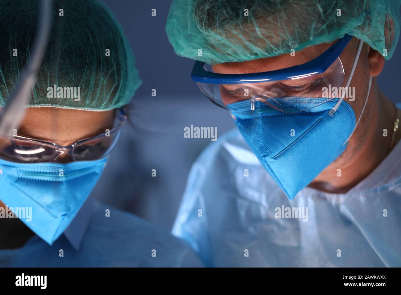 Close-up face of surgeon and assistant at work Stock Photo - Alamy
