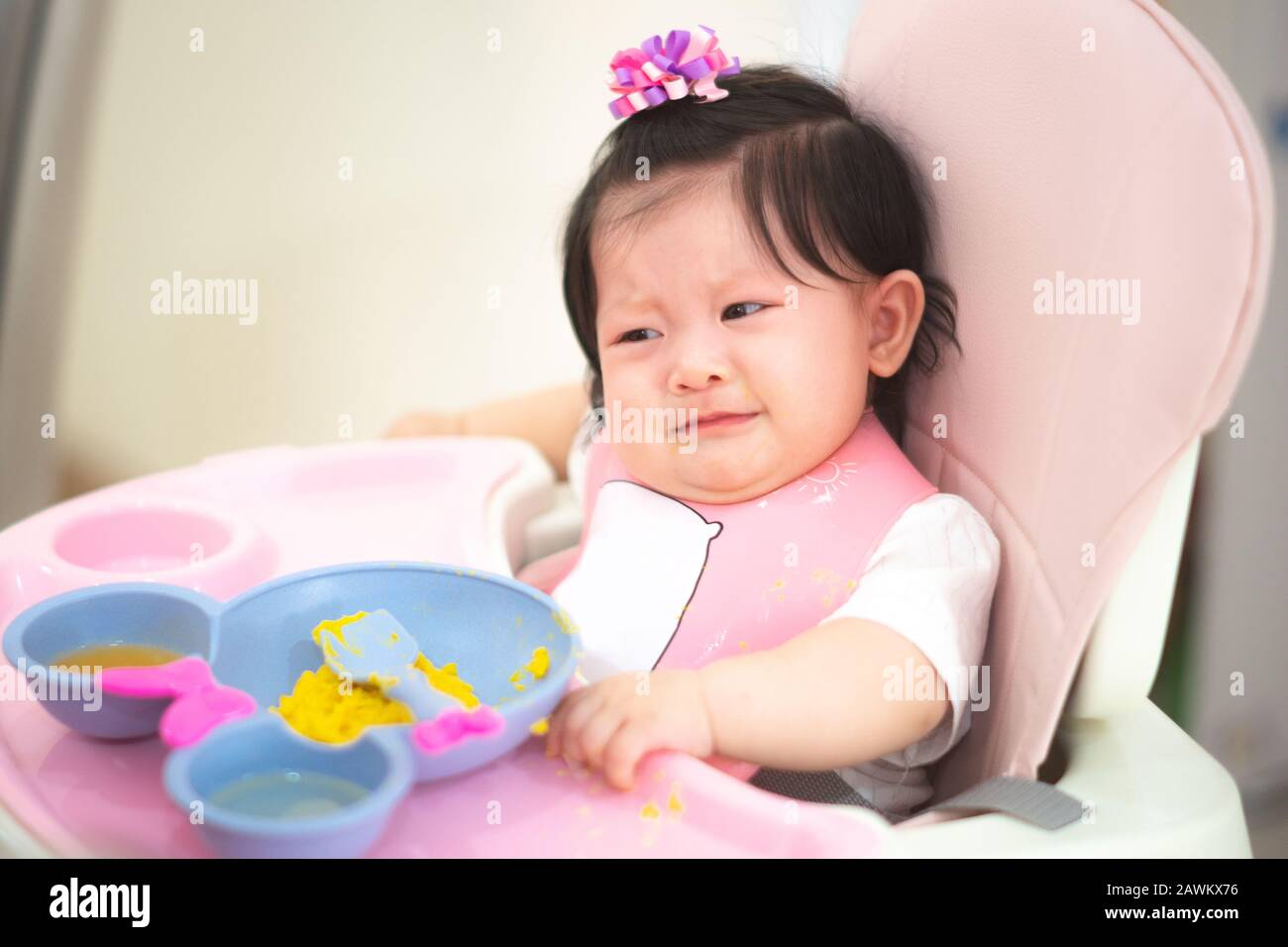 Unpleasant Asian Thai Baby Girl with First Time Meal Stock Photo - Alamy