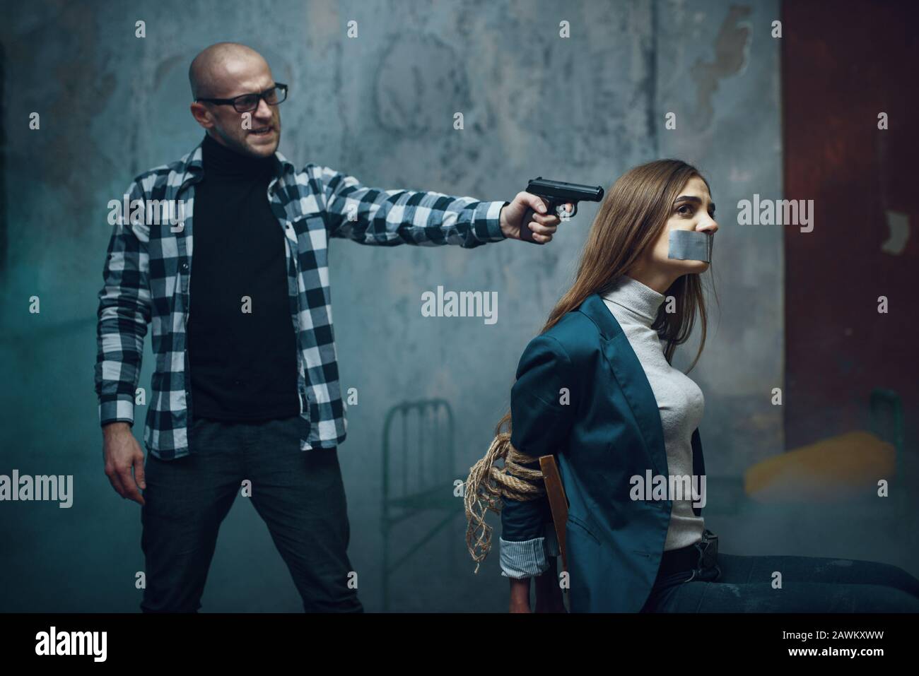 Maniac kidnapper puts a gun to his victim's head Stock Photo - Alamy
