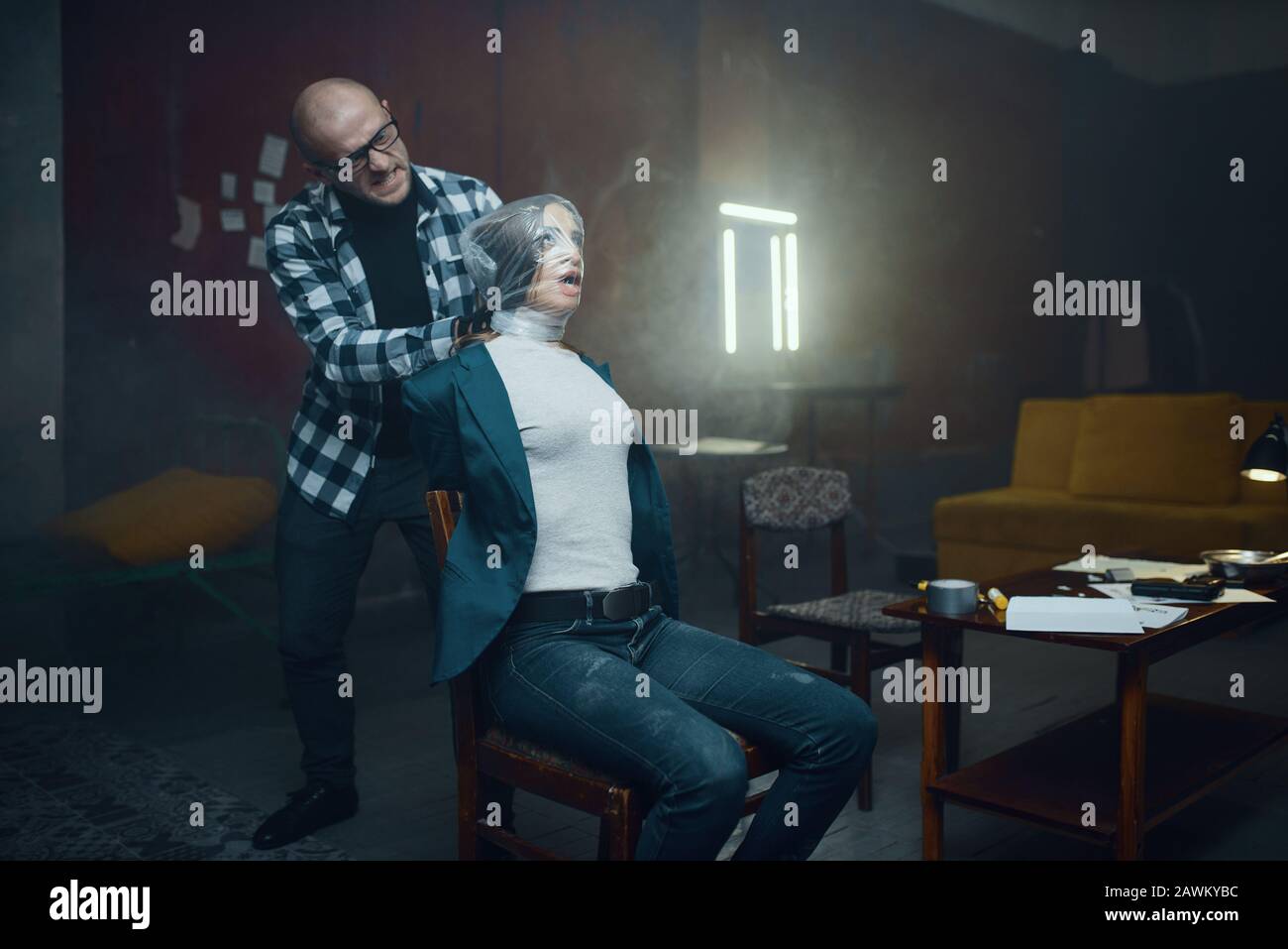 Maniac kidnapper smothers his scared female victim Stock Photo - Alamy