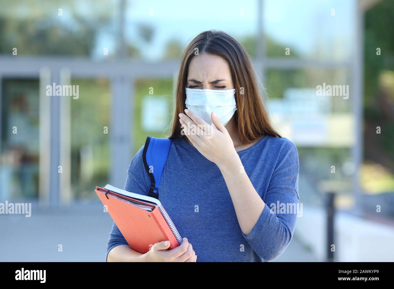 Front view portrait of an ill student wearing a protective mask ...