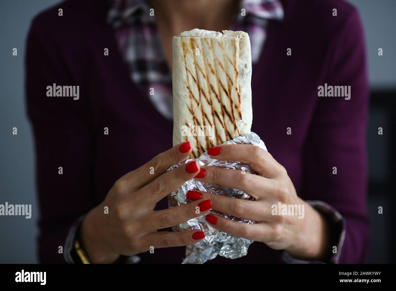 Girl holds delicious shawarma snack during work Stock Photo - Alamy
