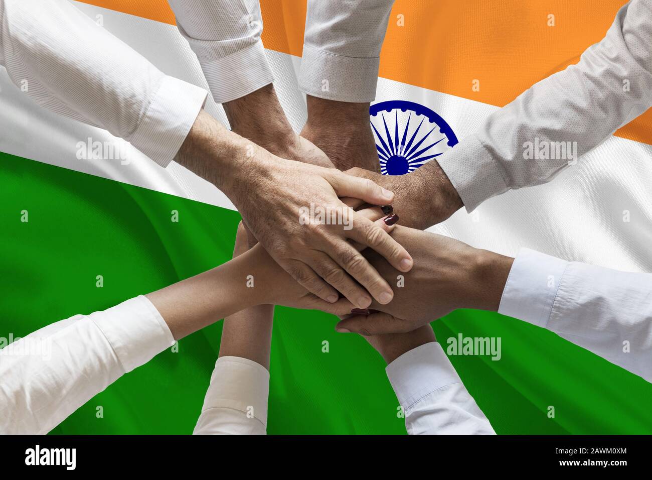 stack of hands showing unity and teamwork over waving indian flag Stock ...