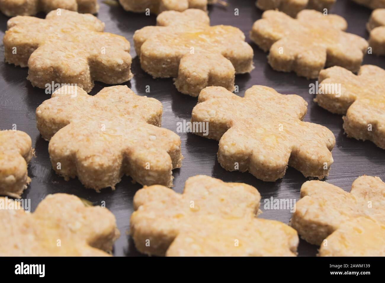 Four-leaf Clover Shaped Raw Cottage Cheese Cookies on Black Baking ...