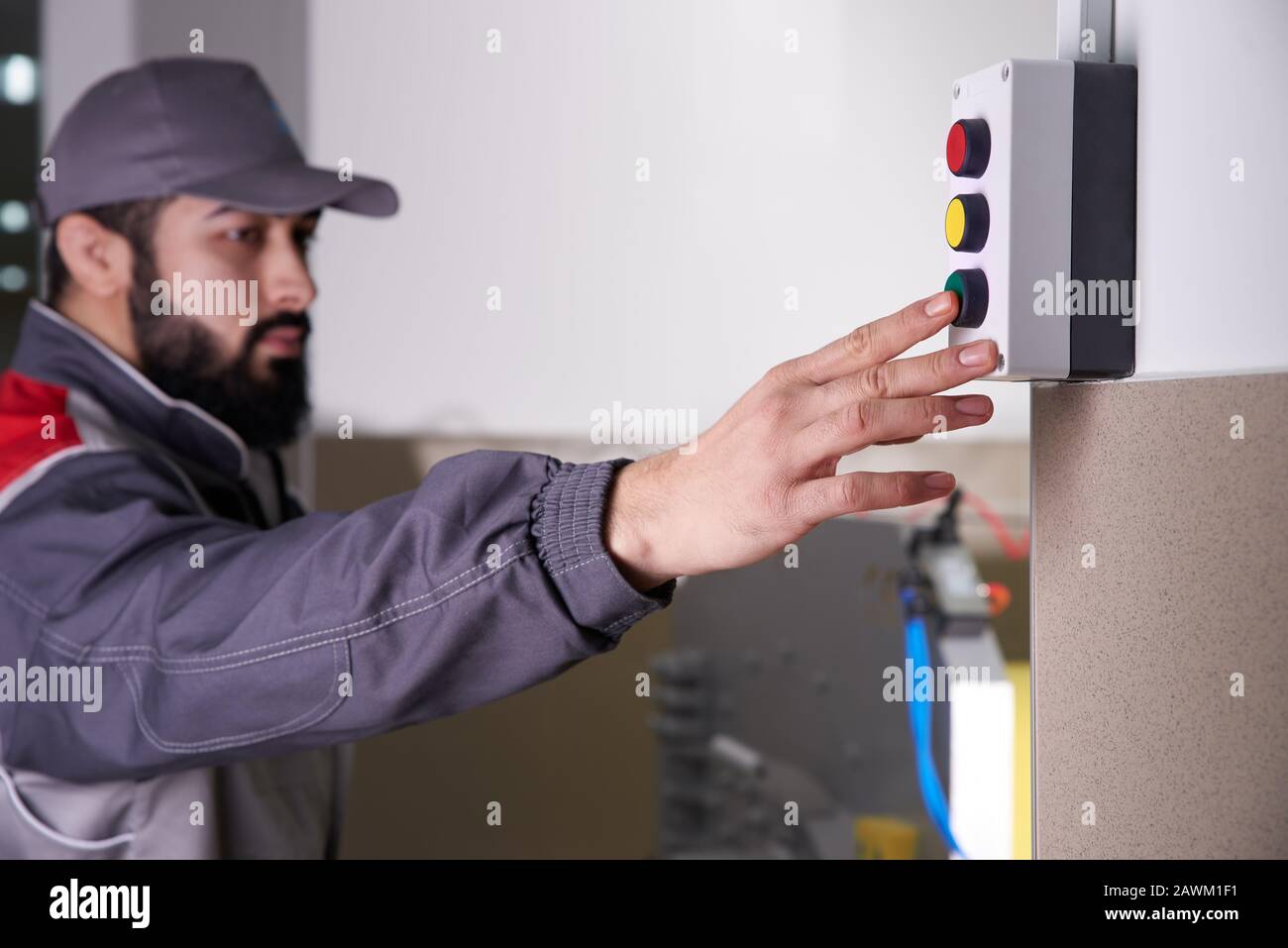 Worker operating a machine in a factory Stock Photo - Alamy