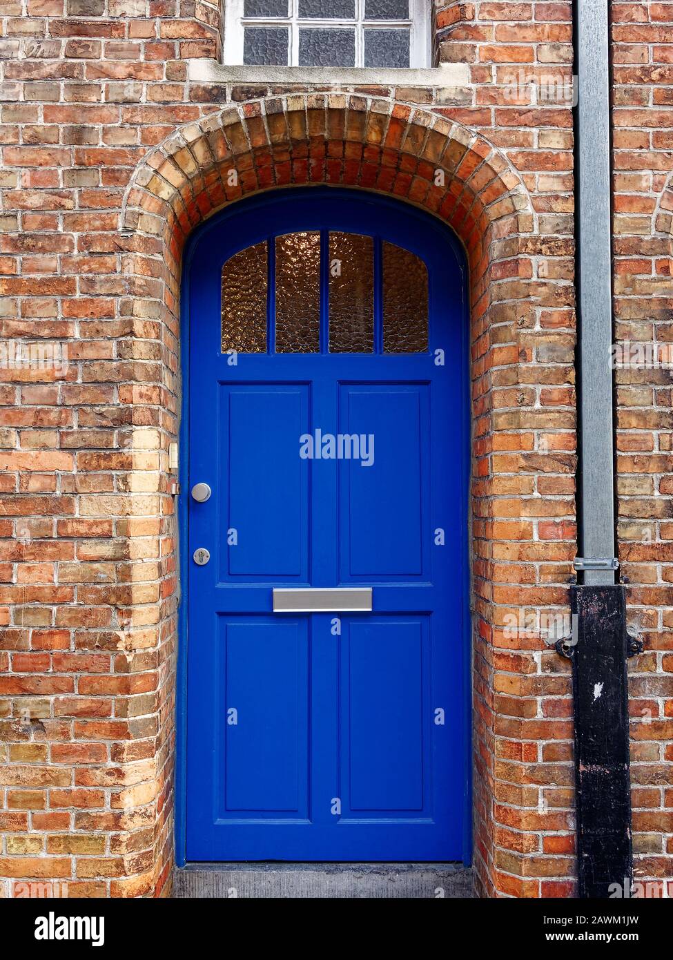 old blue exterior door in brick wall Stock Photo - Alamy