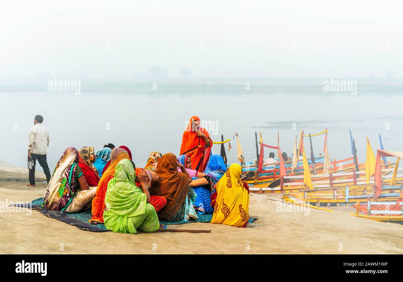 Group of female Hindu pilgrims waiting to catch ferry to cross Yamuna ...
