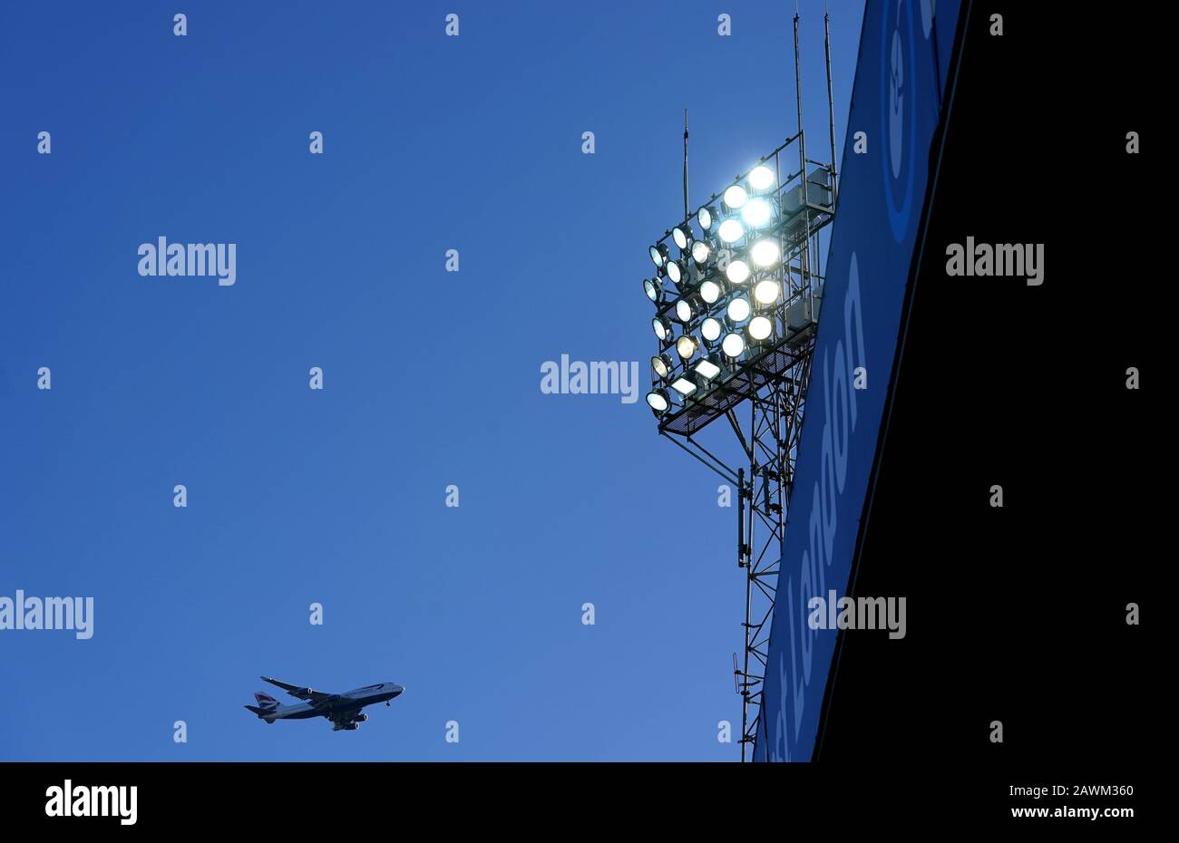 A plane flies over the stadium Stock Photo - Alamy