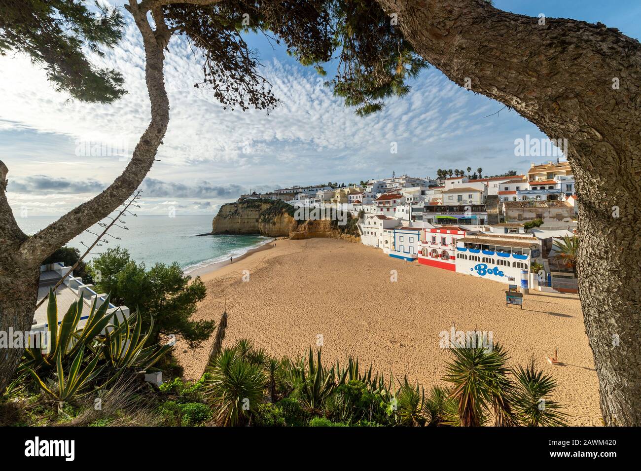 View of beach in Carvoeiro town with colorful houses on coast of ...