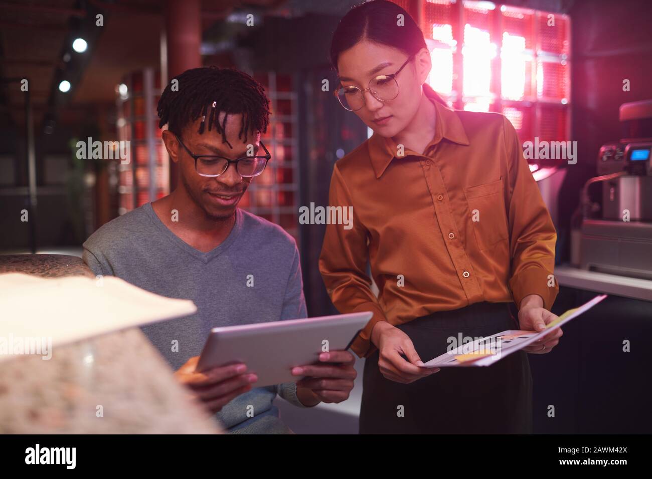 Portrait of contemporary business team working on creative project in ...