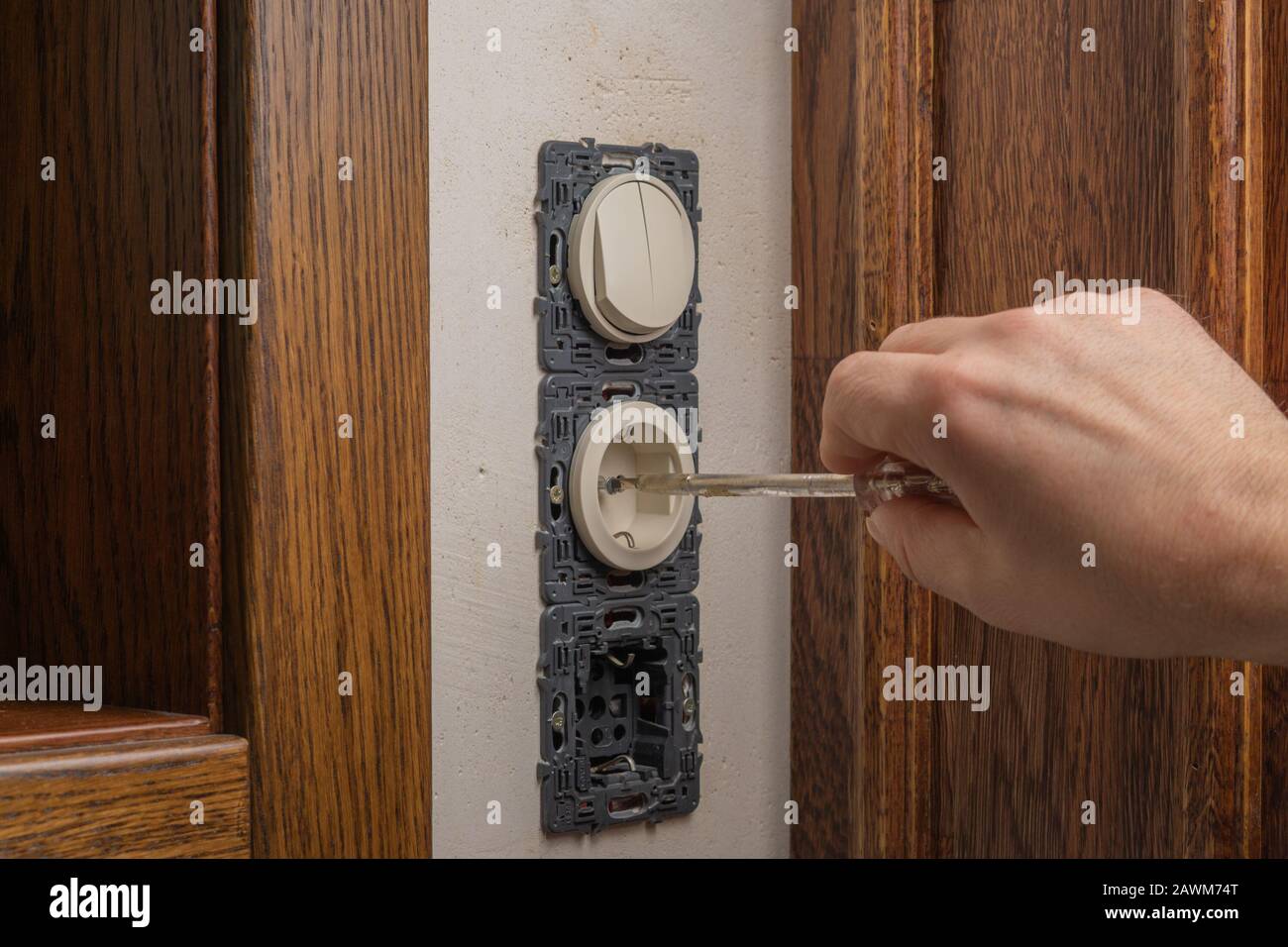 Socket Installation. A master electrician installs an electrical ...