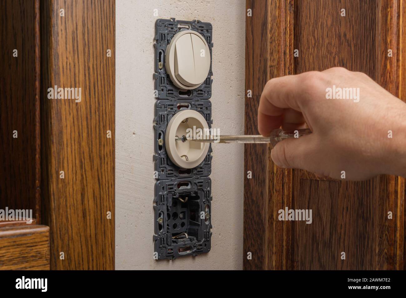 Socket Installation. A master electrician installs an electrical ...