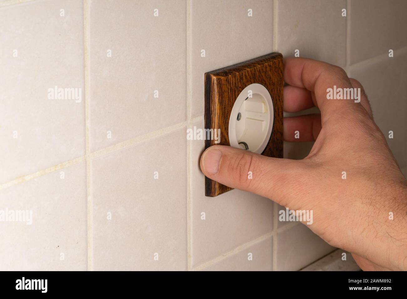 Socket Installation. A master electrician installs an electrical ...
