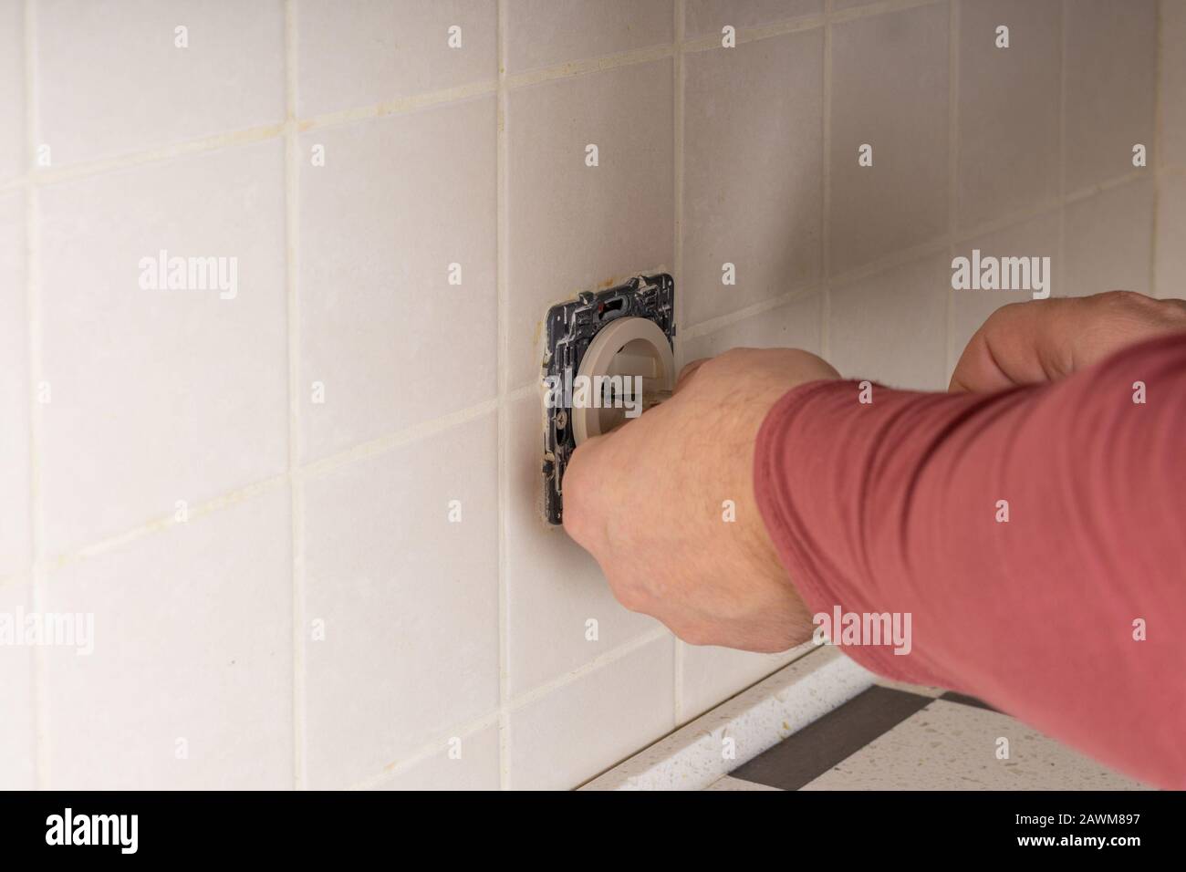 Socket Installation. A master electrician installs an electrical ...