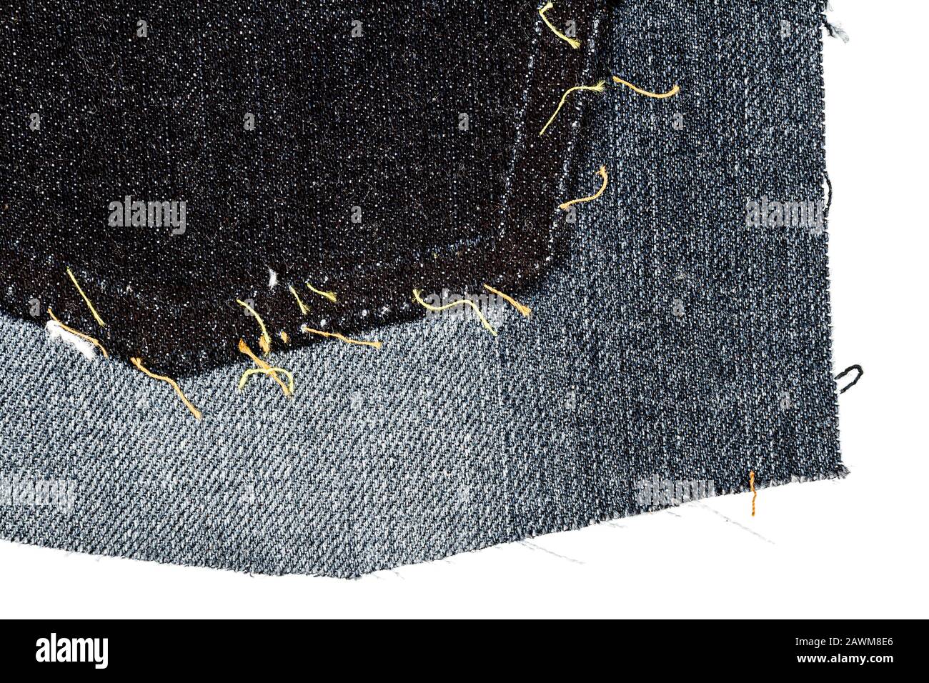 Piece of black jeans fabric with a ripped of back pocket isolated on ...