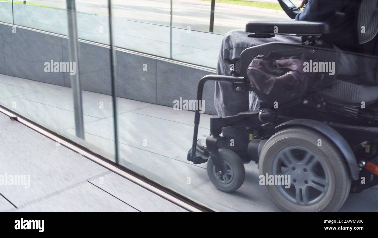 man on electric wheelchair using a ramp. Accessibility concept Stock ...