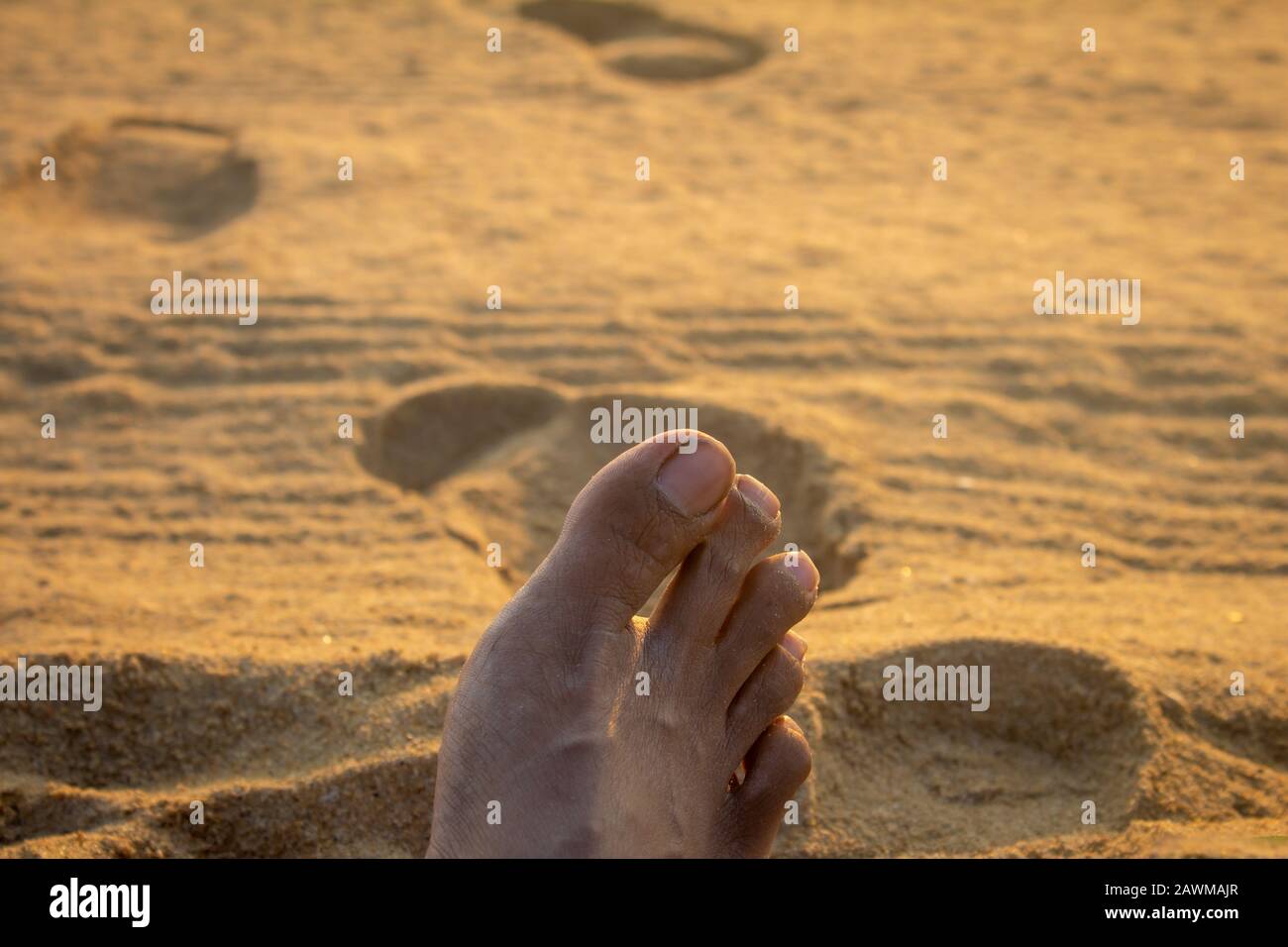 View of human foot over beach sand Stock Photo - Alamy