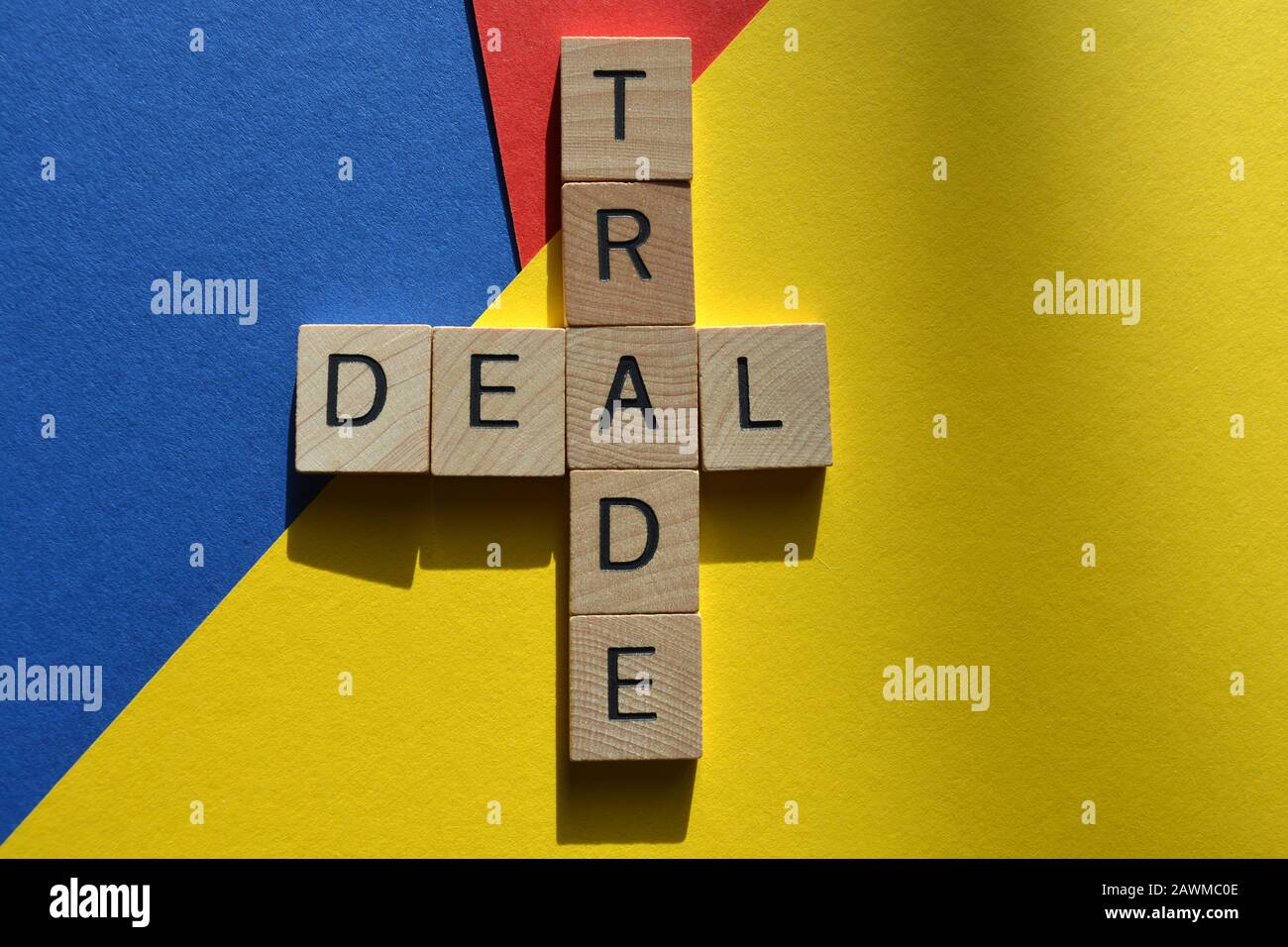 Trade Deal in 3d wooden alphabet letters on a blue, red and yellow ...