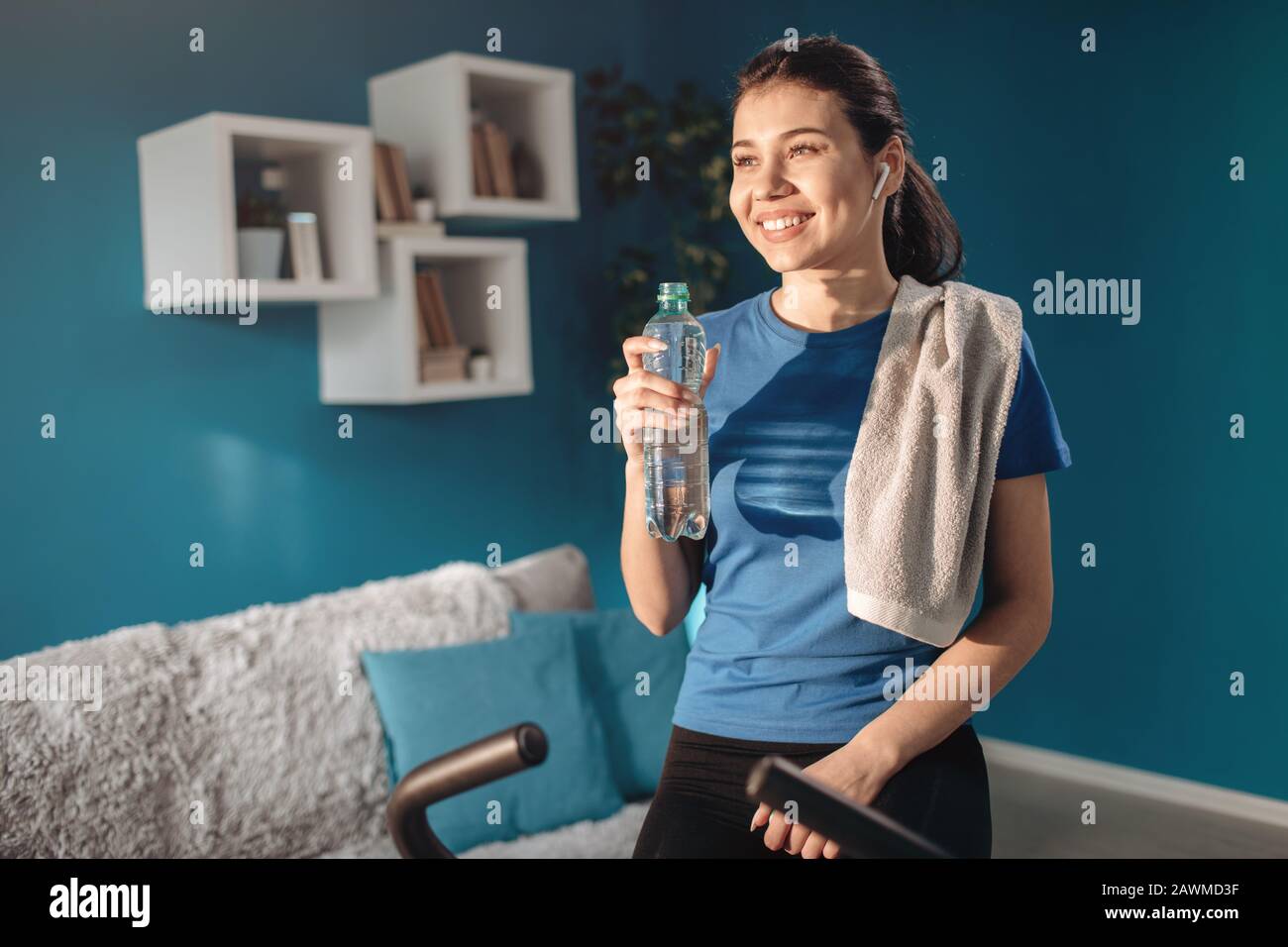 A Smiling Brunette Drinking Water After Workout Stock Photo - Alamy