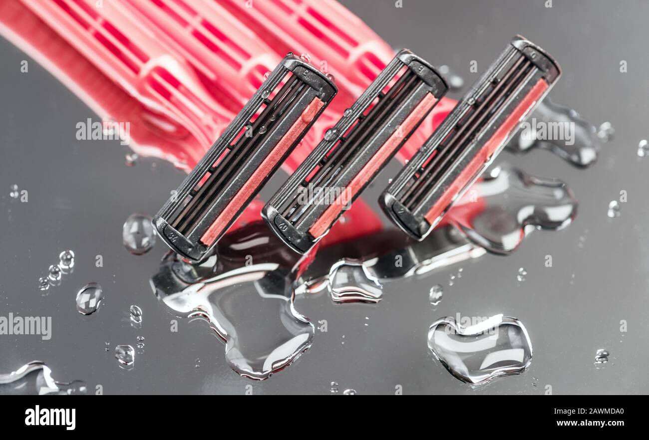 Disposable shaving machine for women on wet mirror background. Removal ...