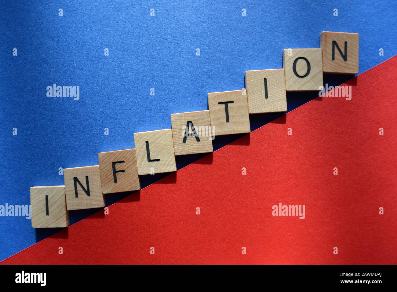 Inflation in 3D wooden alphabet letters on a red and blue background ...