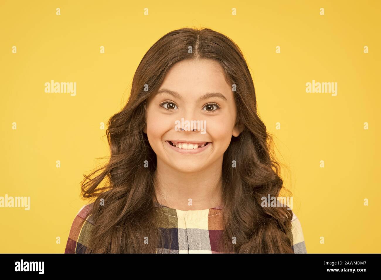 Education that makes child happy. Happy little girl on yellow ...