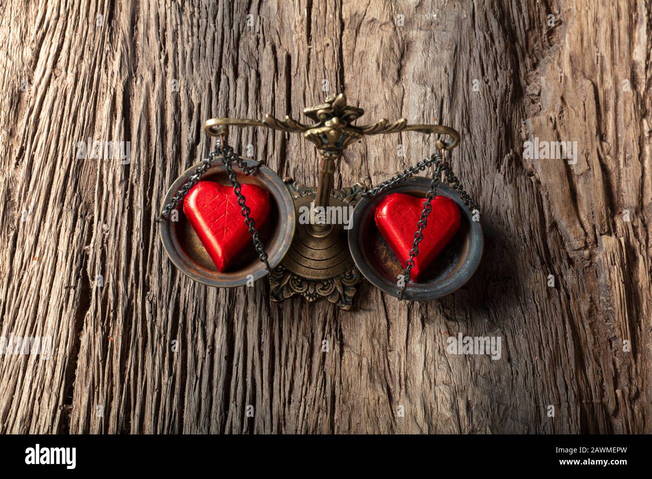 Old fashioned scale showing the advantage of love over money. Heart ...