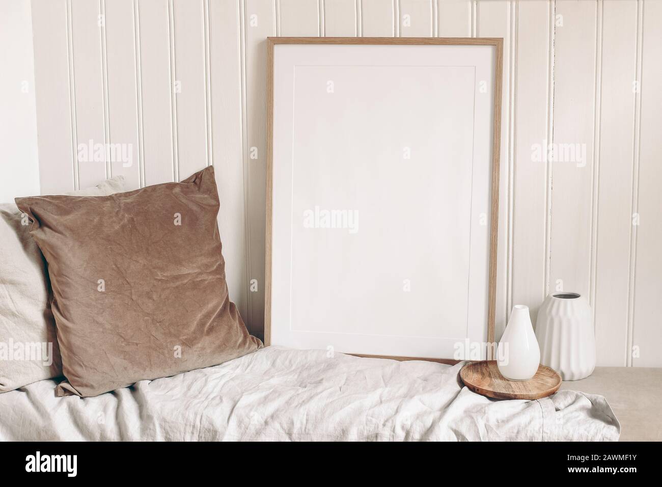 Portrait empty wooden frame mockup with linen cloth, velvet cushions ...