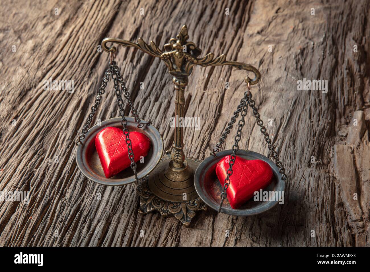 Old fashioned scale showing the advantage of love over money. Heart ...