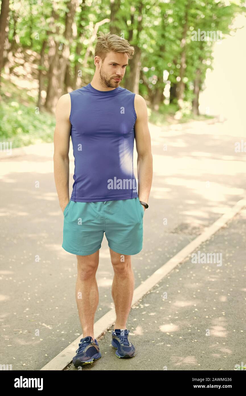 Handsome sportsman in sportswear outdoors. Active sportsman training ...