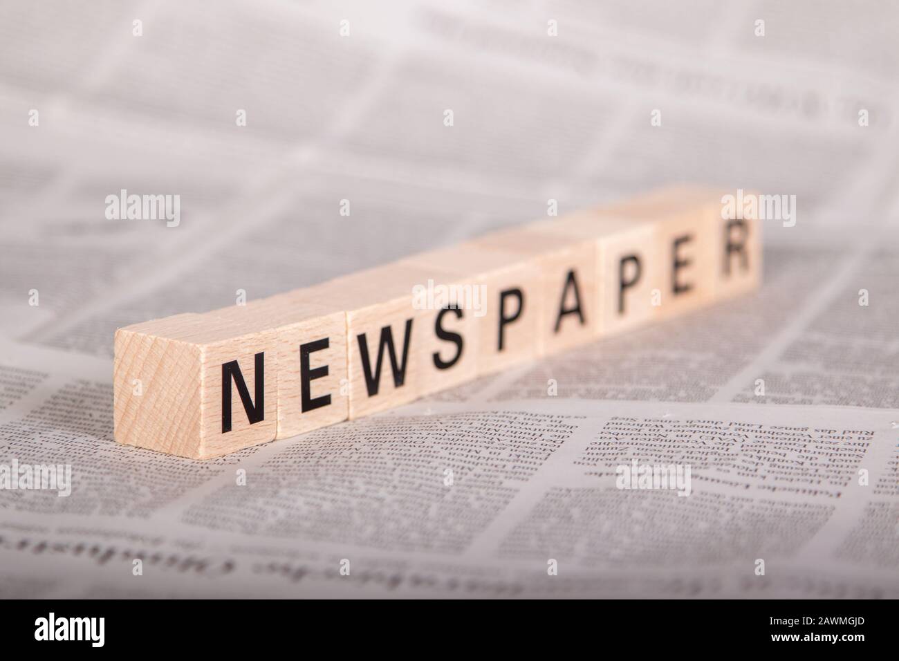newspaper text on wooden cubes, newspaper as background, perspective ...