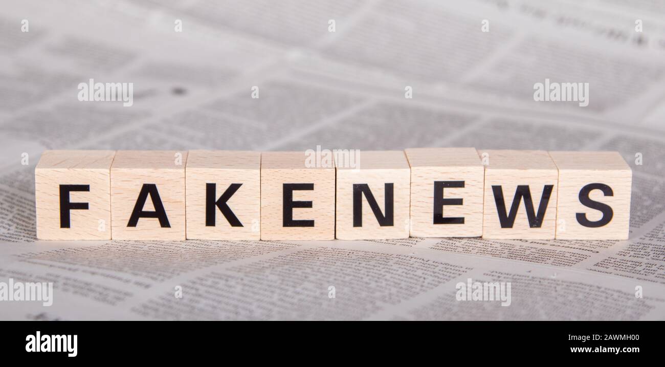fakenews text on wooden cubes, newspaper as background Stock Photo - Alamy