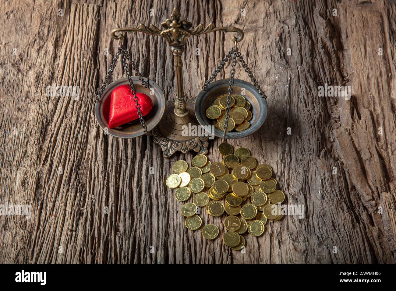 Old fashioned scale showing the advantage of love over money. Heart ...