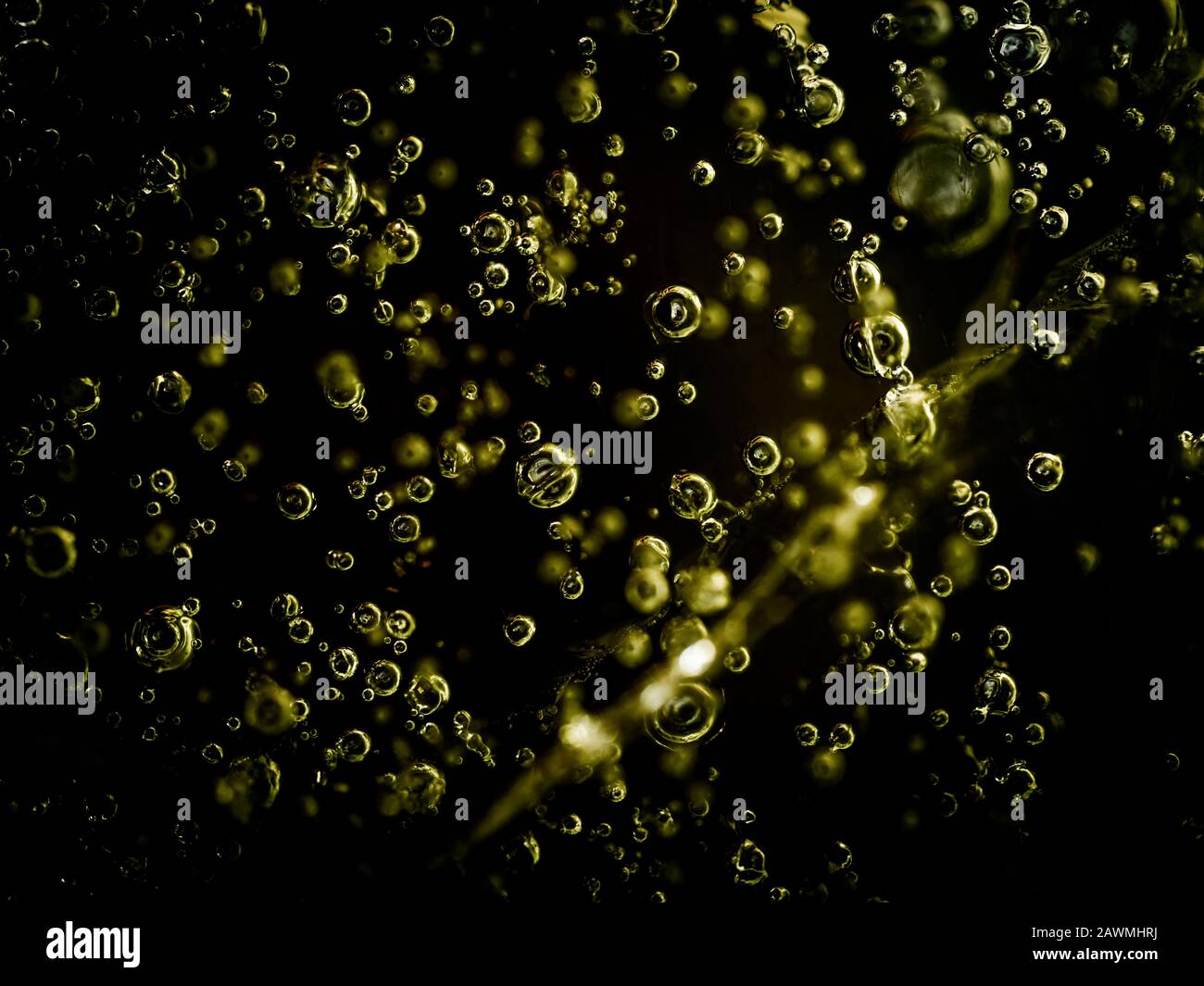 Water bubbles frozen in ice. White bubbles frozen in black ice ...