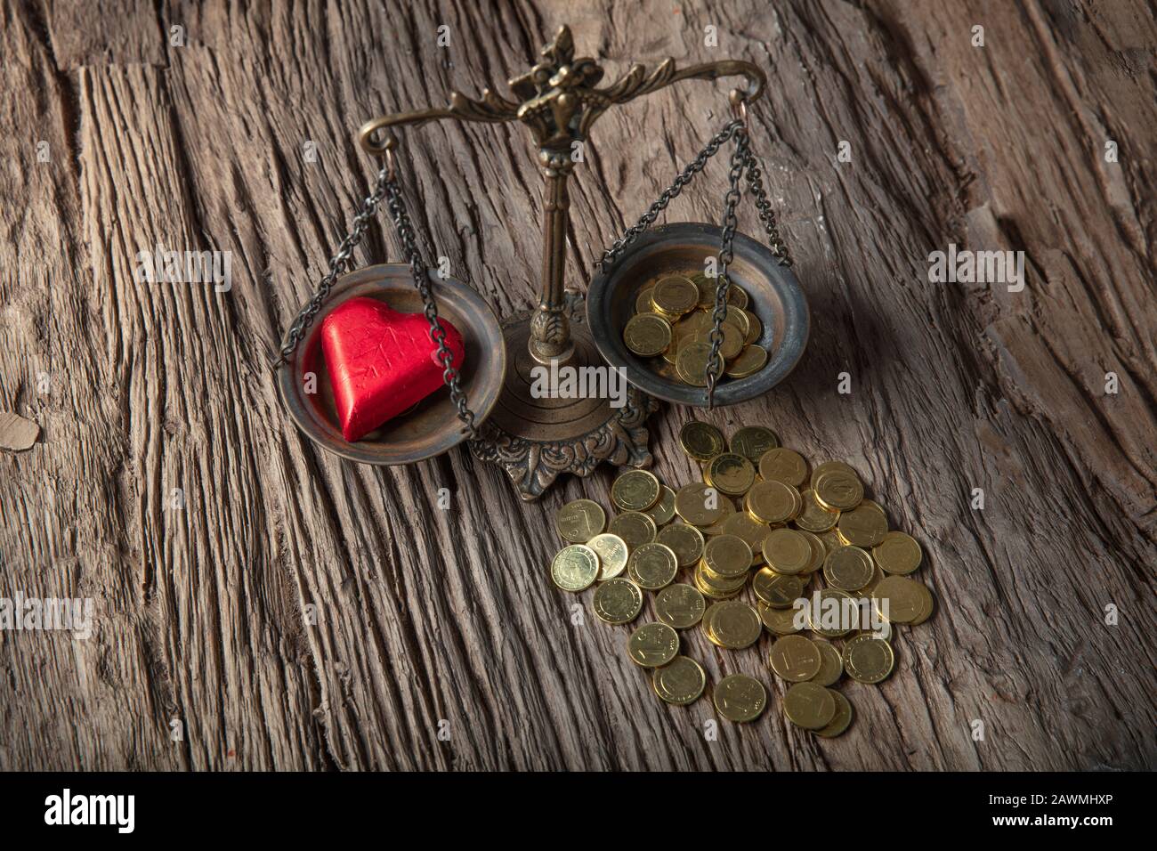 Old fashioned scale showing the advantage of love over money. Heart ...