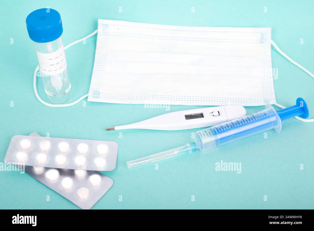 cold remedies. test tube, syringe, pills and medical mask respirator ...